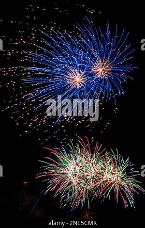 Vertical image of a fireworks display with wind affecting the ...