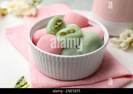 Delicious mochi in bowl on light grey marble table, top view with space ...