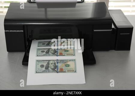 Printing dollar banknotes on grey table, closeup. Fake money concept ...