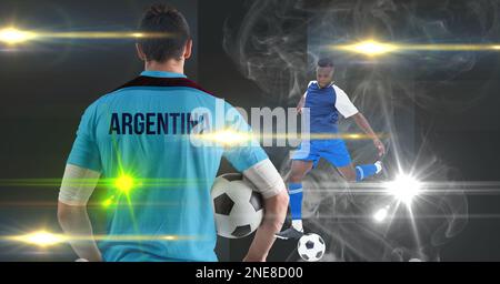Smoke effect over two male soccer players against spot of lights on ...