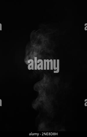 White steam column rising on black background Stock Photo - Alamy