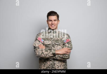 Portrait of happy cadet on light grey background Stock Photo - Alamy