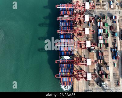 LIANYUNGANG, CHINA - FEBRUARY 16, 2023 - Cargo ships unload containers ...