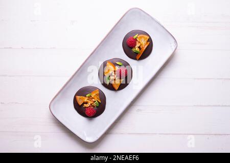 Chocolate dessert with candied orange, raspberry and nuts Stock Photo ...