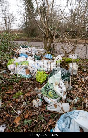 Litter thrown out in a woodland area in a layby on a roadside, Cumbria ...