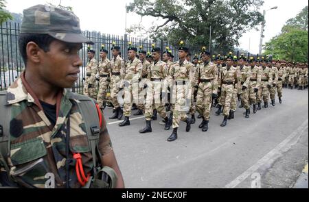 A Sri Lankan army soldier stands guard during the funeral ceremony of ...