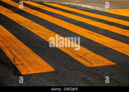 Yellow painted crosswalk road line markings Stock Photo - Alamy