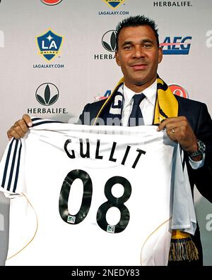 Former Dutch soccer star Ruud Gullit poses with a fan during a ...