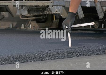 Checking the asphalt surface course Stock Photo - Alamy