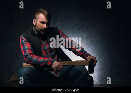 Dangerous-looking axeman. Lumberjack with weapon Stock Photo - Alamy