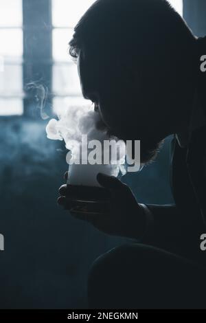 drinking a cold drink or beverage with smoke from cooling down drinking ...