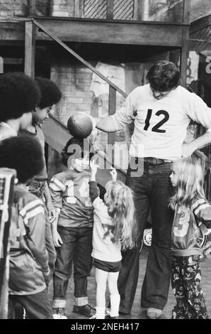 Joe Namath plays football with kids on "Sesame Street." The show is ...