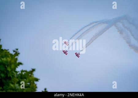 An acrobatic Aviation team flying close while performing stunts in red ...