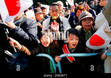 Japanese well-wishers wave national flags and lanterns in front of the ...