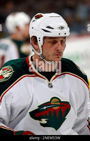 Minnesota Wild left winger Derek Boogaard, center, looks on as his shot ...