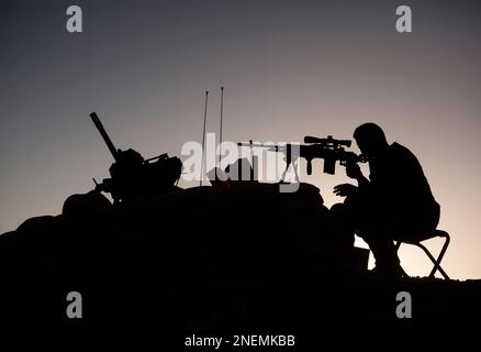A sniper from the U.S. Army 10th Special Forces Group (Airborne) rests ...