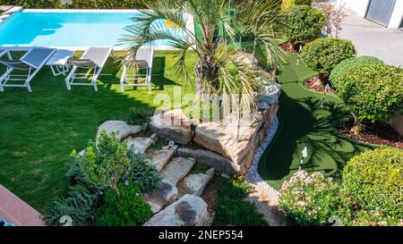 Installation of natural grass and golf course around the front yard ...