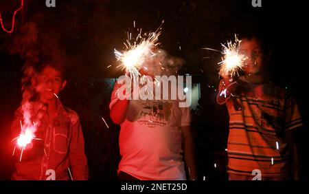 Children play with firecrackers during Diwali celebrations in New Delhi ...