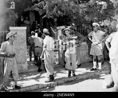 An Israeli soldier carries out arms to a waiting truck from the armoury ...