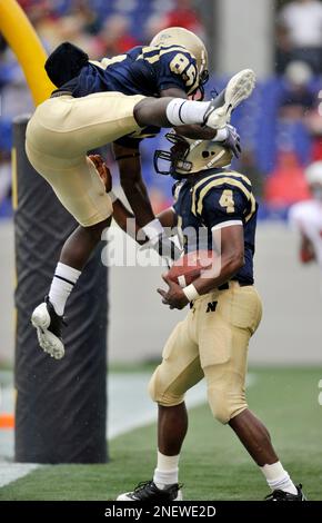 Navy quarterback Ricky Dobbs (4) celebrates with Vonn Banks, left ...