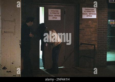Police officer escorting man in handcuffs Stock Photo - Alamy
