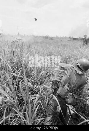A soldier with a grenade in Vietnam. From the Eddie Adams series "Hands ...