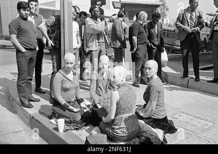 Four young women members of the Charles Manson "family" kneel on the ...