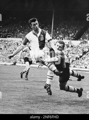 Wolverhampton Wanderers goalkeeper Malcolm Finlayson (r) tips the ball over the bar, watched by ...