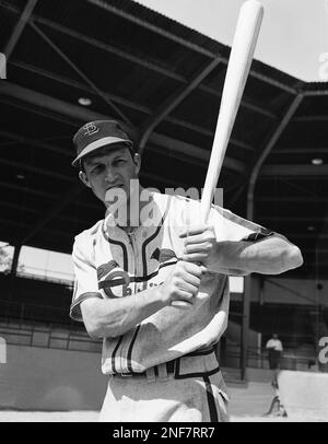 Stan Musial, St. Louis Cardinals' first baseman, picks out a bat before ...