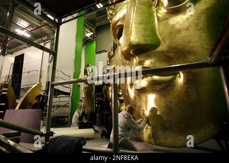 Large British Academy Film mask statues are cleaned and polished on set ...