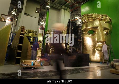 Large British Academy Film mask statues are cleaned and polished on set ...