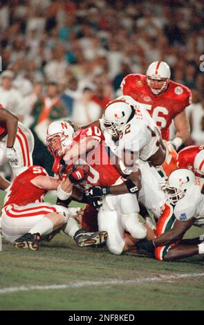 Nebraska fullback Cory Schlesinger (40) outruns Miami safety Malcolm ...