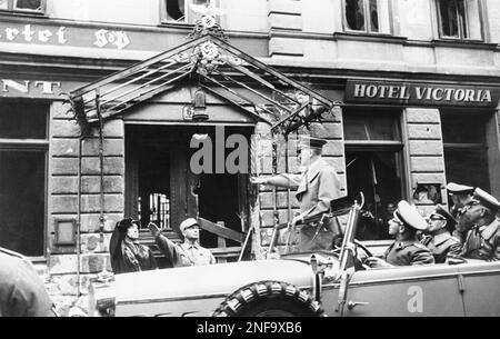German leader Adolf Hitler stands in his convertible. Reproduction of ...