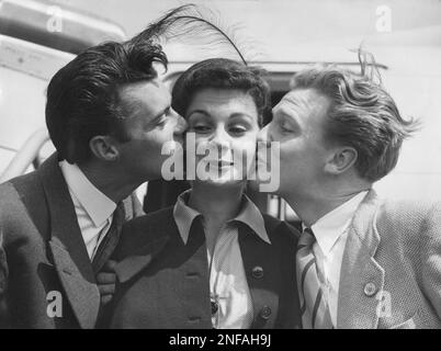 British actress Jean Simmons, 20, poses in front of a poster of her ...
