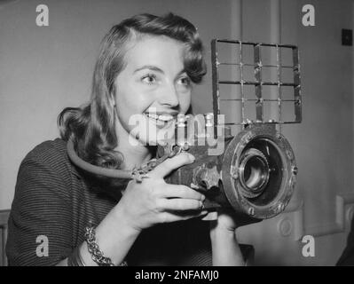 Dr. Hans Hass. Lotte Hass surfaces for a rest during a diving ...