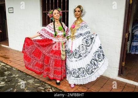 Two Panamanian women wearing the colorful traditional pollera, the ...