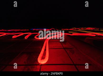 Illuminated letters and words made with neon lights and blue LEDs of ...