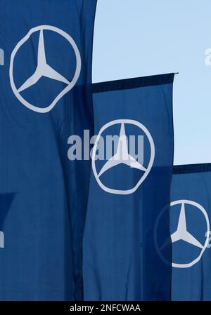 Flags with the Mercedes-Benz logo are seen in front of the Mercedes ...