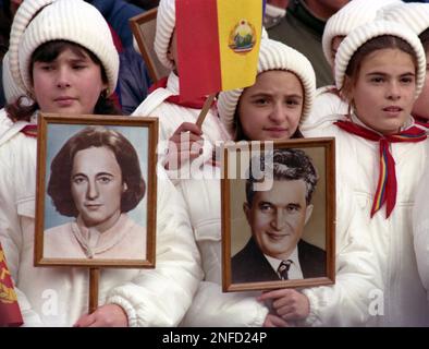 Romanian leader Nicolae Ceausescu addresses the public from the balcony ...
