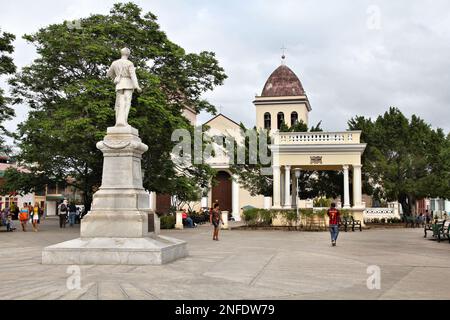 HOLGUIN, CUBA - FEBRUARY 16, 2011: People walk by Chevrolet classic ...