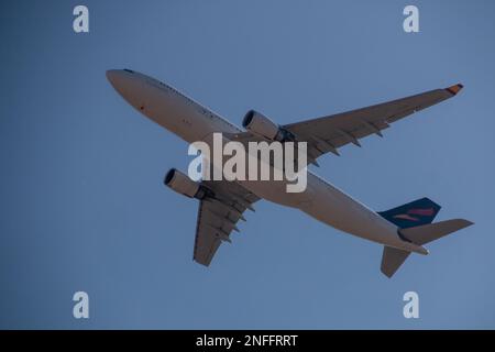 Plane ascending into the sky, flying, on its takeoff from the airport ...