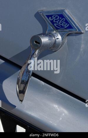 Locking boot lid handle of a grey classic Riley car, showing some ...