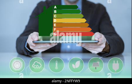 Man calculating energy buildings efficiency class. Ecological and bio ...