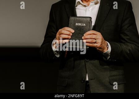 Pastor with a Bible in his hand during a sermon. The preacher delivers ...