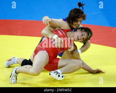 Kyoko Hamaguchi, of Japan, in blue, wrestles against Elena Perepelkina ...
