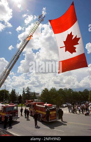 A pumper truck carries the flag draped casket of firefighter Bob Leek ...