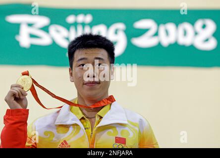 China's Wei Pang shows off his gold medal during medal ceremony at the ...