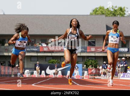 Marshevet Hooker, center, crosses the finish line during the semifinals ...