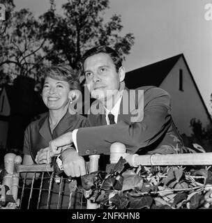 Actor Louis Jourdan and his wife, Berthe Fredrique, look over a ...