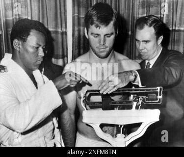 American boxer Thad Spencer, left, does a bit of fancy footwork to ...